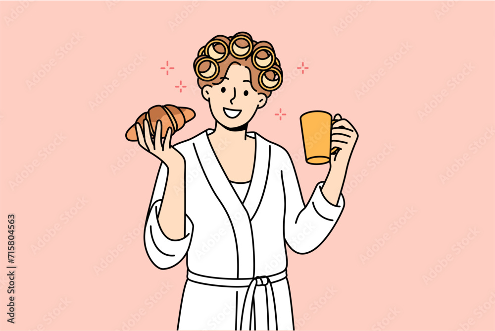 Woman enjoys morning breakfast of fresh croissant and cup coffee ...