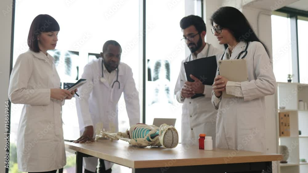 African man medical teacher teaching anatomy to university students or ...