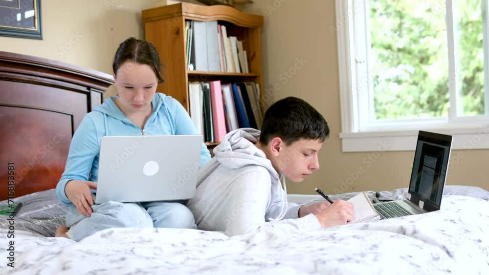 Two caucasian children watching something funny on laptop. Attractive ...