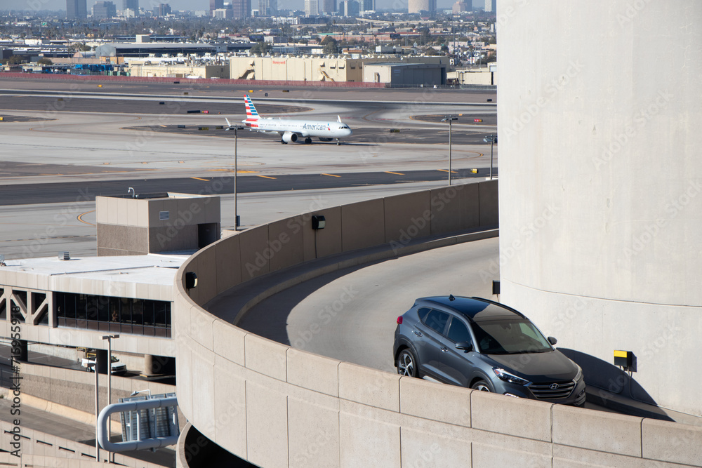 Aerial view of a vehicle moving down a parking structure ramp, with an ...