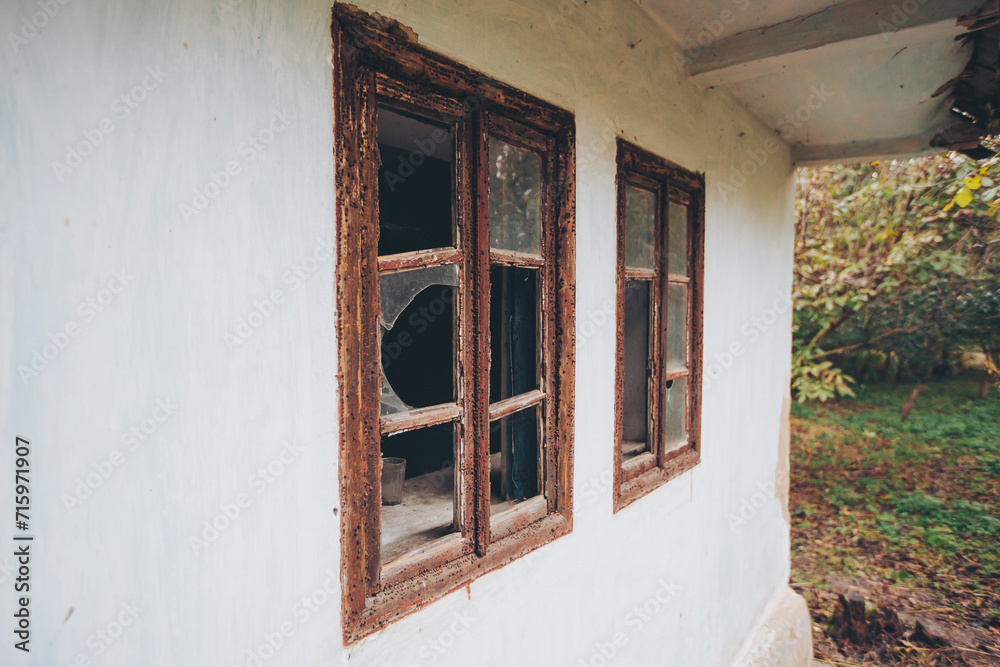 an abandoned broken windows. Old destroyed houses. Broken glass in the window. War, destruction ...