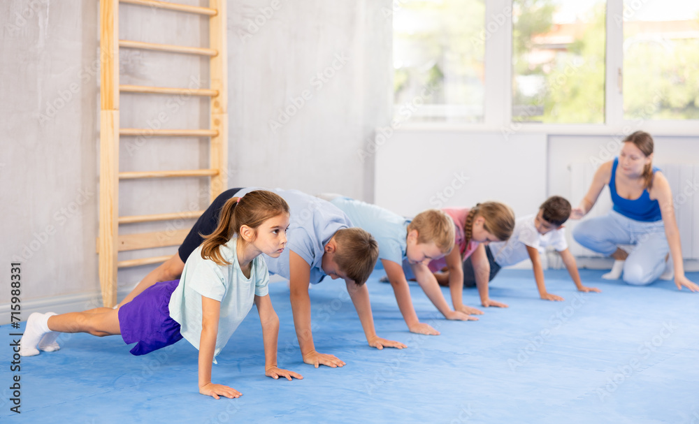 Children perform push-ups and prepare for main martial arts training ...