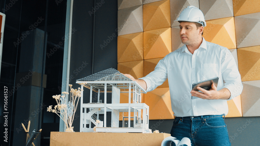 Professional caucasian architect engineer using tablet analysis house ...