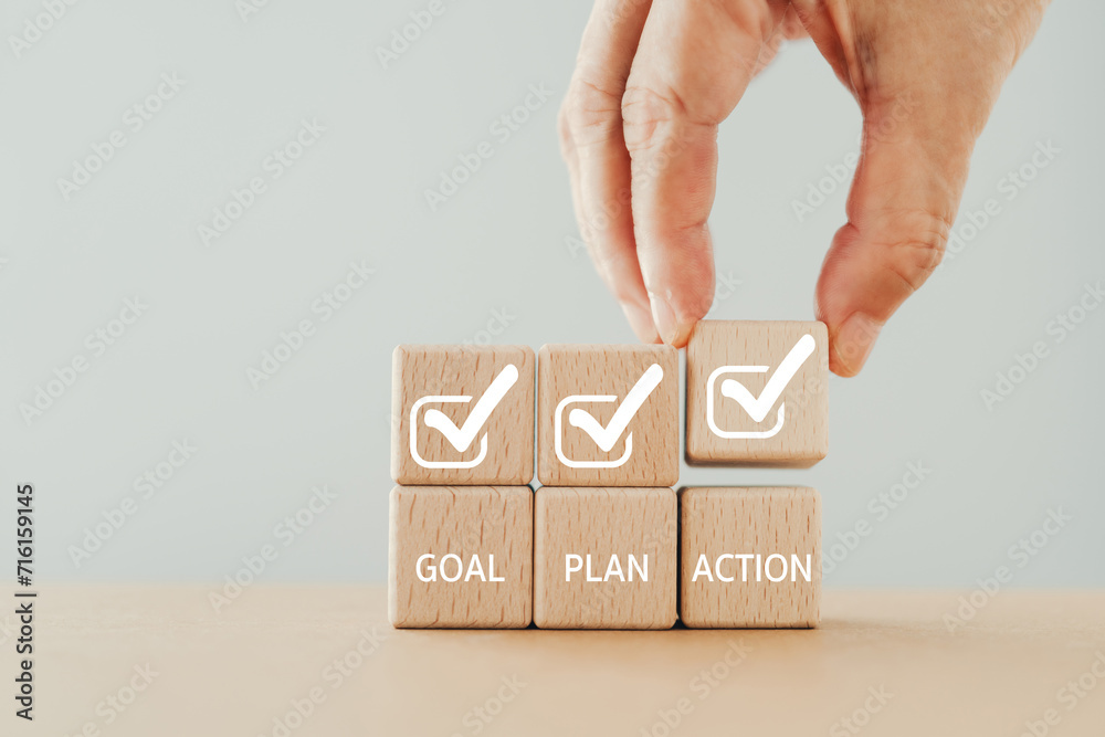 Hand completed Goal, Plan, Action text and check box on wooden cube ...
