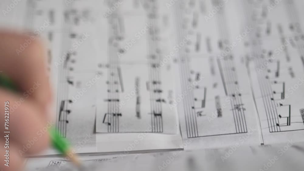 Music notes .hand traces music symbols on music sheets. Music sheets in ...