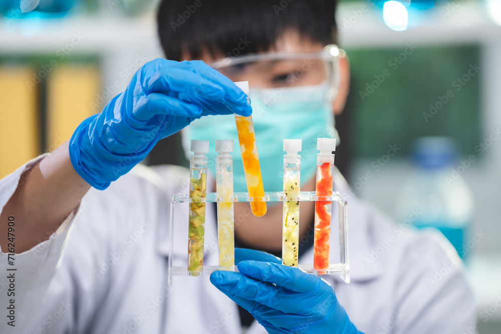 Scientist or researcher is holding a sample of fruit sample in test ...