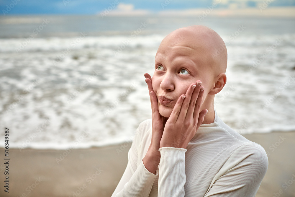 Hairless girl with alopecia make faces in white futuristic costume on ...