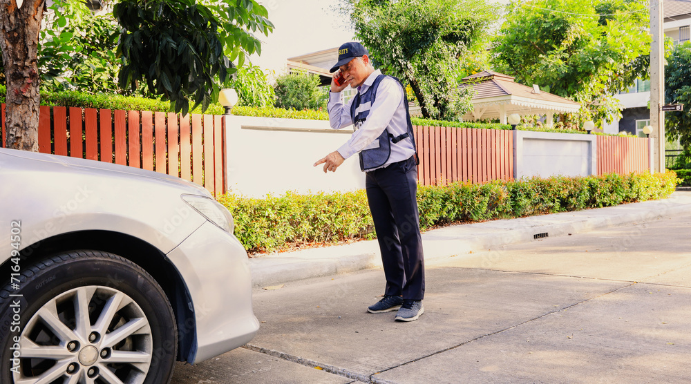 Senior security guards asian in the housing estate check the license ...