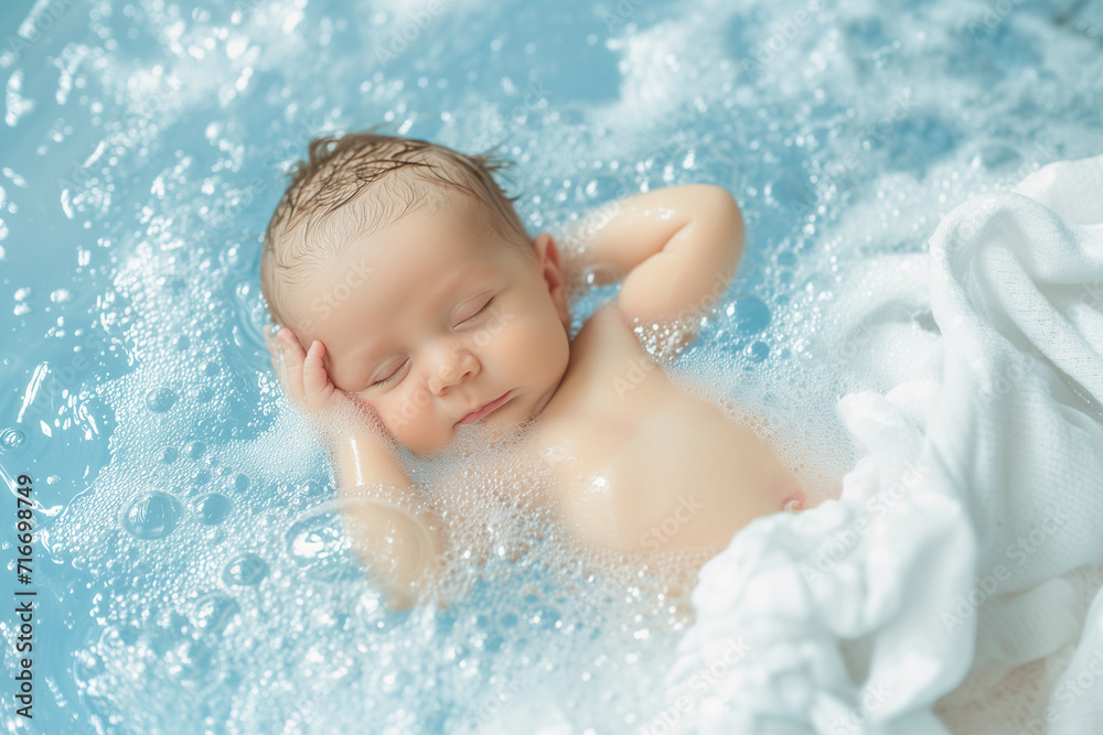 Newborn baby in calm blue water tub, birth card, new life Stock Photo ...