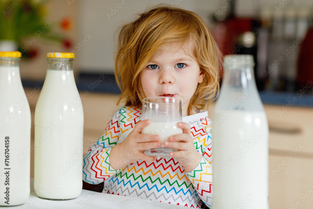 Adorable toddler girl drinking cow milk for breakfast. Cute baby ...