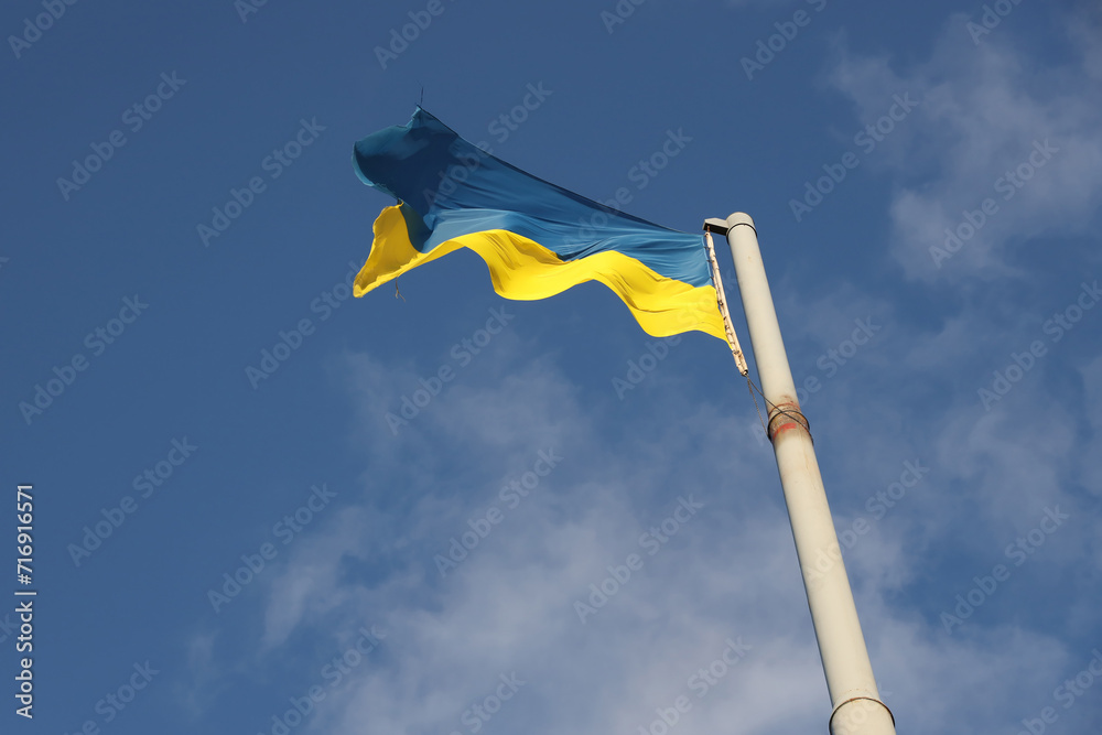 Ukraine flag large national symbol fluttering in blue sky. Large yellow ...