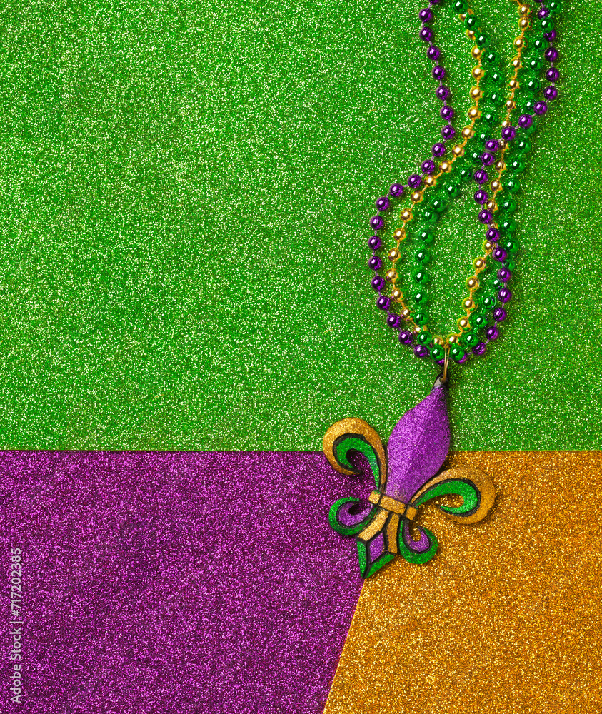 Mardi Gras beads with Fleur de lis, in glittering green, purple, and ...