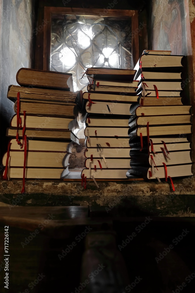 Stack of religious books on a window sill or window stool in the Church ...