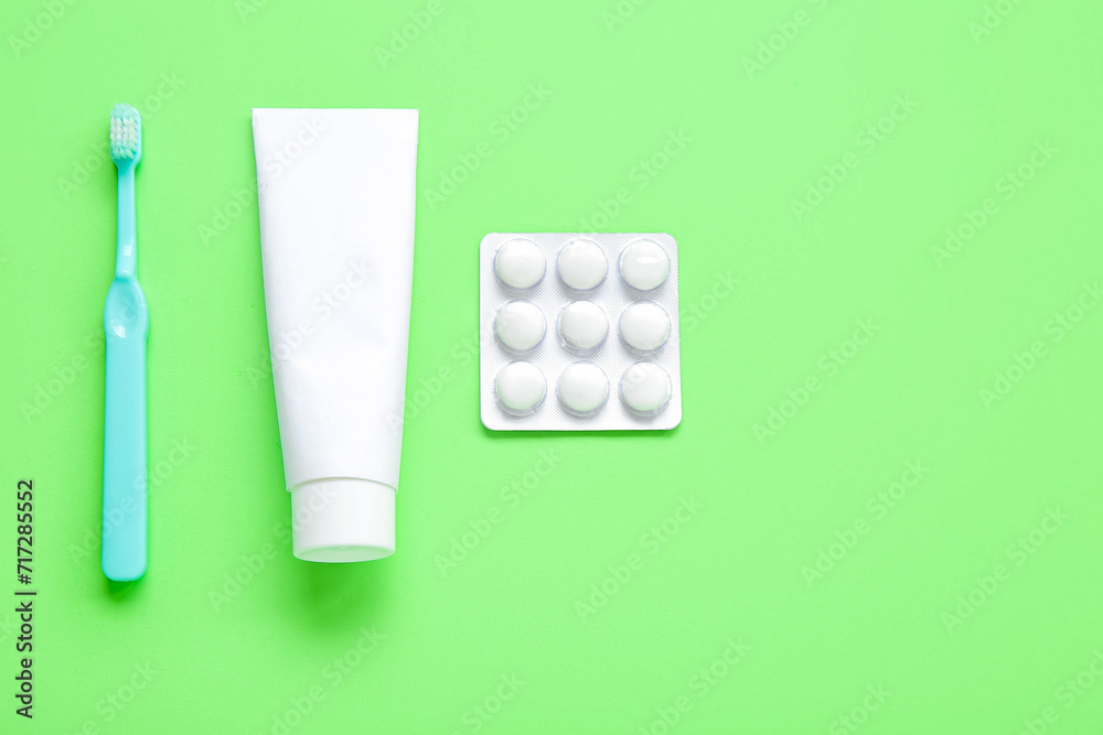Toothpaste and brush with chewing gums on green background Stock Photo ...