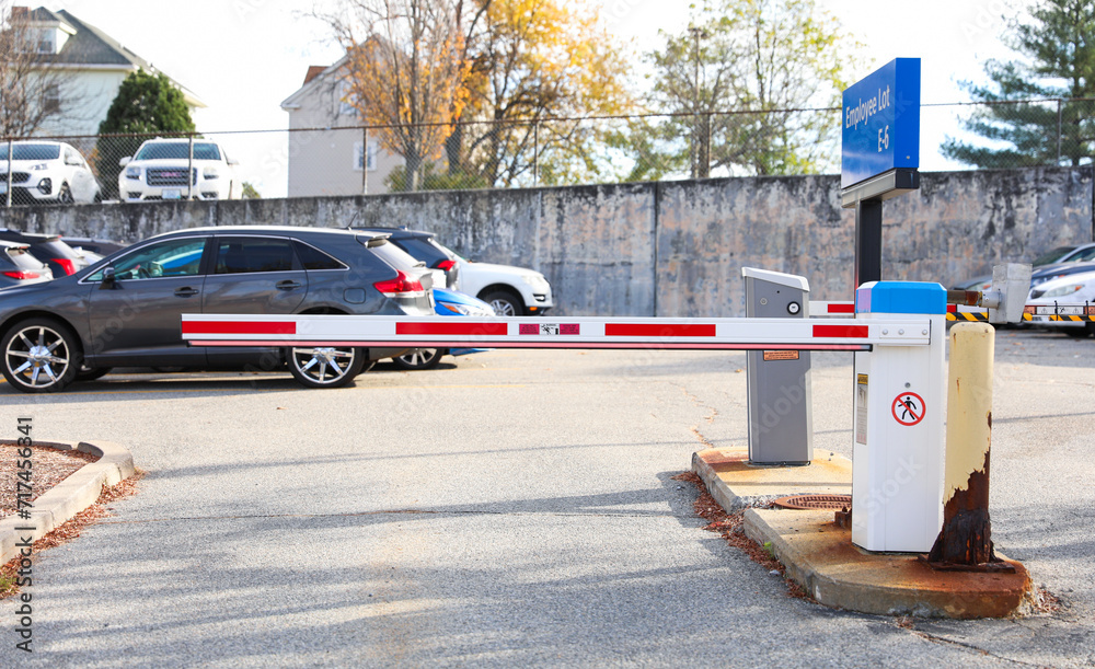 closed parking lot gate, representing barriers, access control, and ...