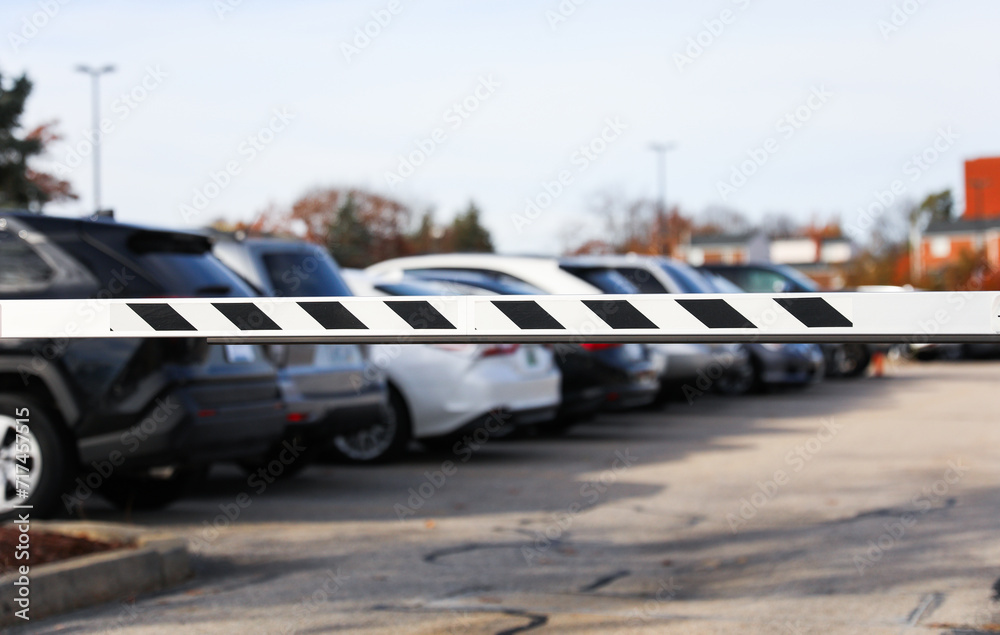 closed parking lot gate, representing barriers, access control, and ...