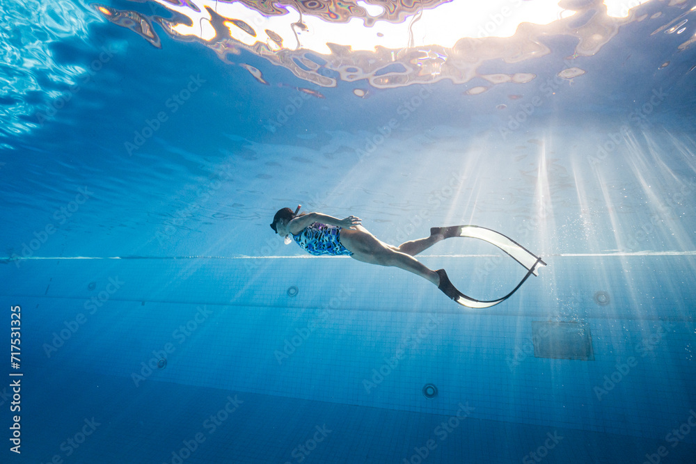 Beauty freediver Asian women diver with fins glides underwater in ...