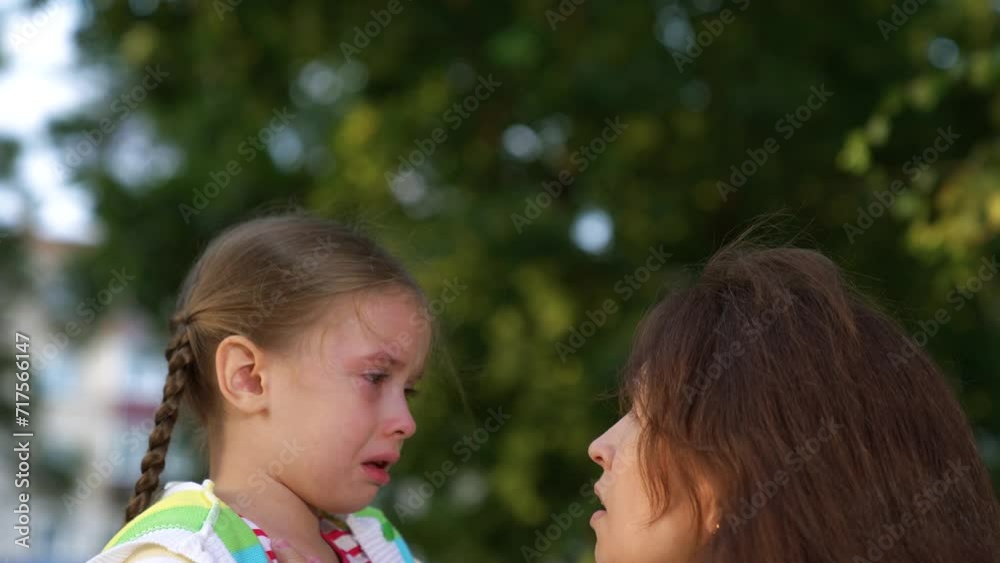 little child cries, tears child face, mother calms capricious kid girl ...