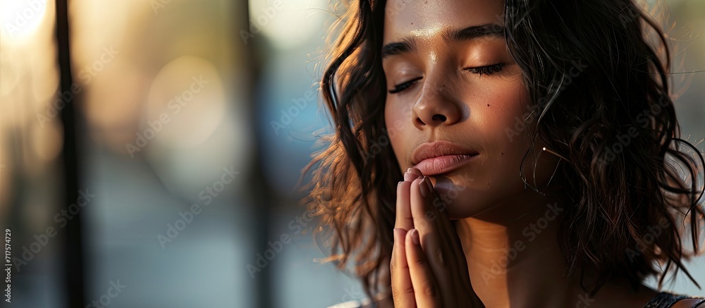 One young hispanic black woman in joining hands in prayer Meditative ...