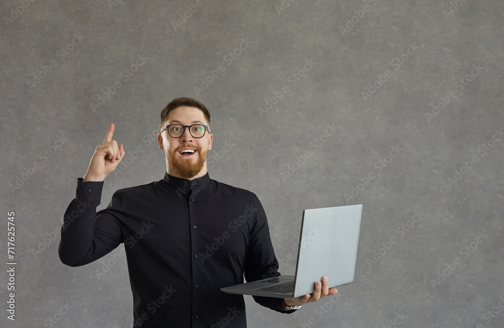 Portrait of funny nerdy bearded young man in glasses isolated on grey ...