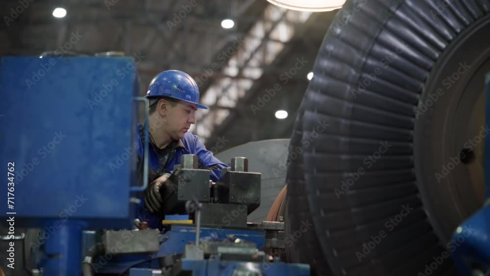 A Worker is inspecting the turbine generator produced at the ...