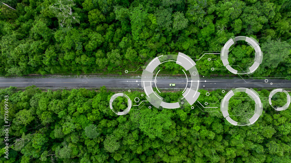 Aerial top view of green electric vehicle car driving over straight ...