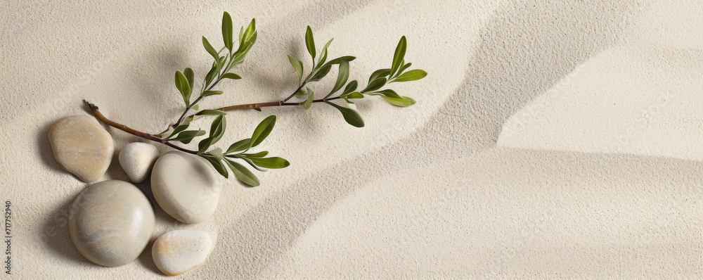 Smooth pebbles and sprigs of greenery arranged artistically on raked ...