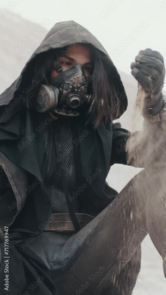 Vertical shot post apocalyptic female wanderer wearing grunge hooded ...