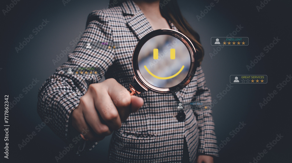 Woman using magnifying glass focus to virtual smile face icon. popup ...