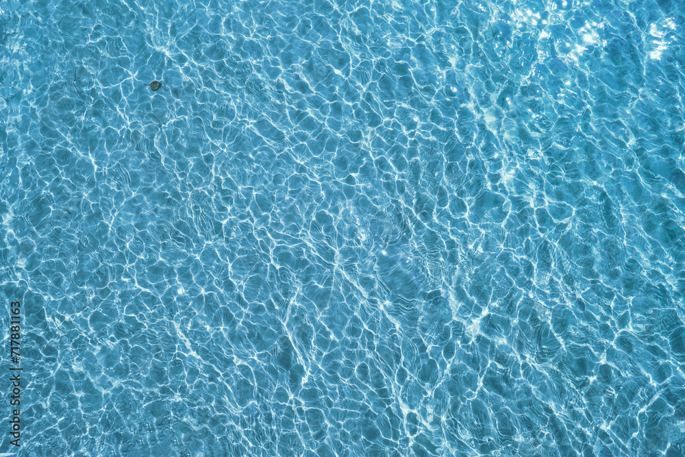 Blue water surface viewed from above in outdoor sea, sun reflection ...