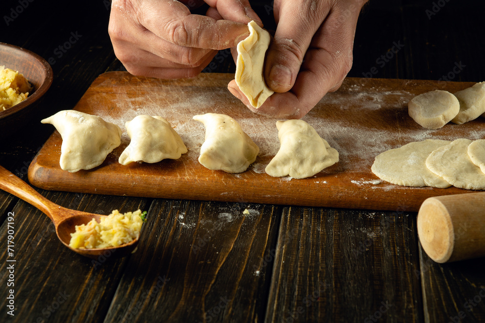 The chef is making dumplings with his hands. Step-by-step process of ...