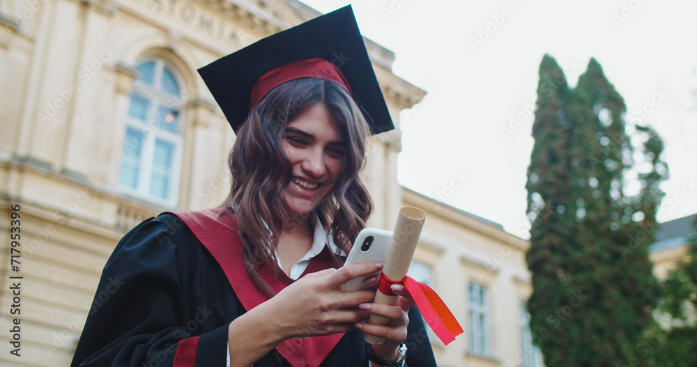 Caucasian young pretty and cheerful master graduated girl in academic ...