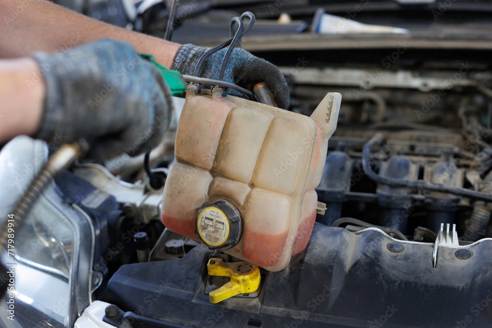 Water tank of the engine cooler. Repair of a car at a service station ...