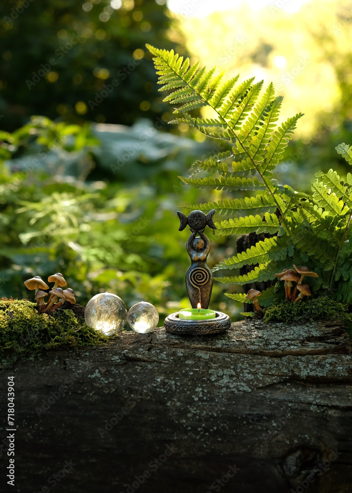 wiccan Goddess ritual figurine with candle and crystal balls in forest ...