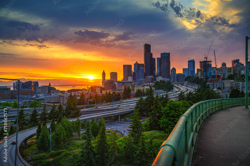 Dramatic sunset over the Seattle skyline, with traffic on the I-5 and I ...