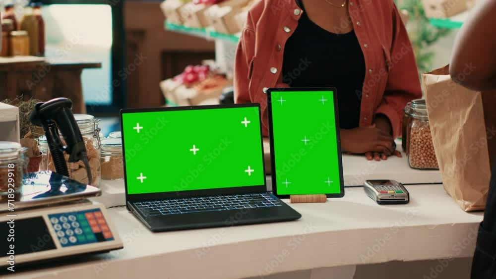Laptop and tablet showing greenscreen at grocery store, supporting ...