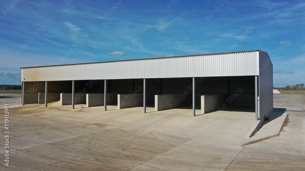 Hangar for fodder storage on a dairy farm. Open-type storage for fodder ...