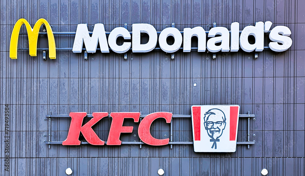 LATVIA, RIGA, 15, JANUARY, 2024: McDonald's and KFC logo on a striped ...