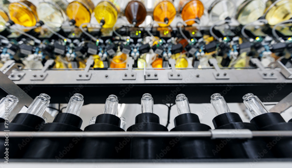 Automated perfume bottling Process, closeup of aroma water bottles ...