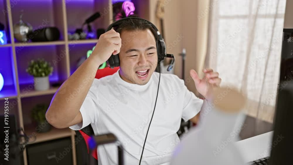 Gaming streamer, young chinese man pulled an all-nighter, smiling wide ...