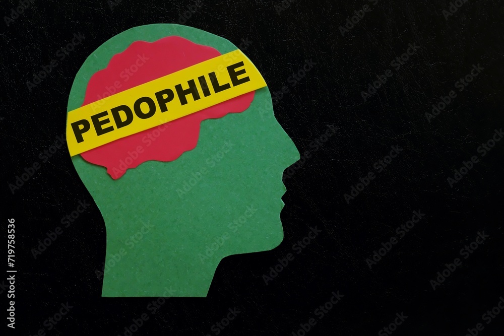 Human head profile with word pedophile in dark black background ...