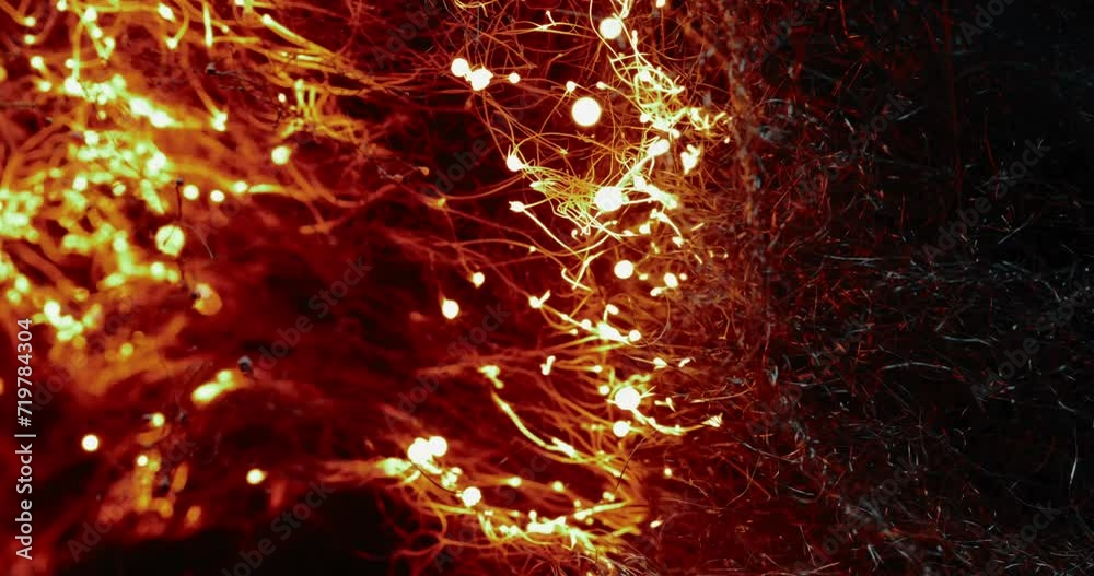 ARTISTIC FIRE TRAILS: A small group of glowing fire bursts rises up on ...