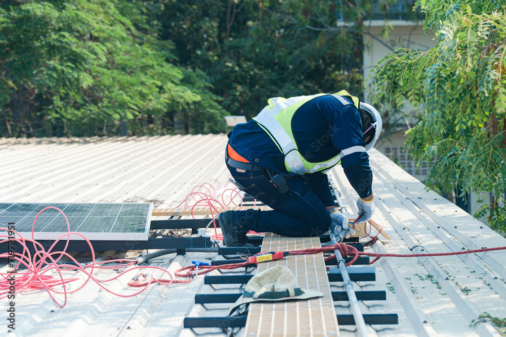 Worker Technicians are working to construct solar panels system on roof ...