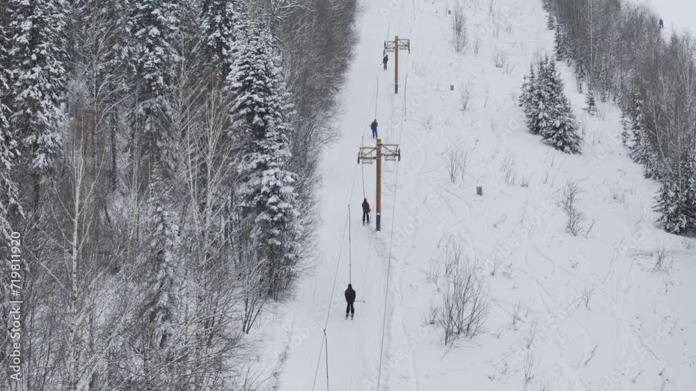 Ski lift rope tow snowy ski resort rope tow in winter forest setting ...