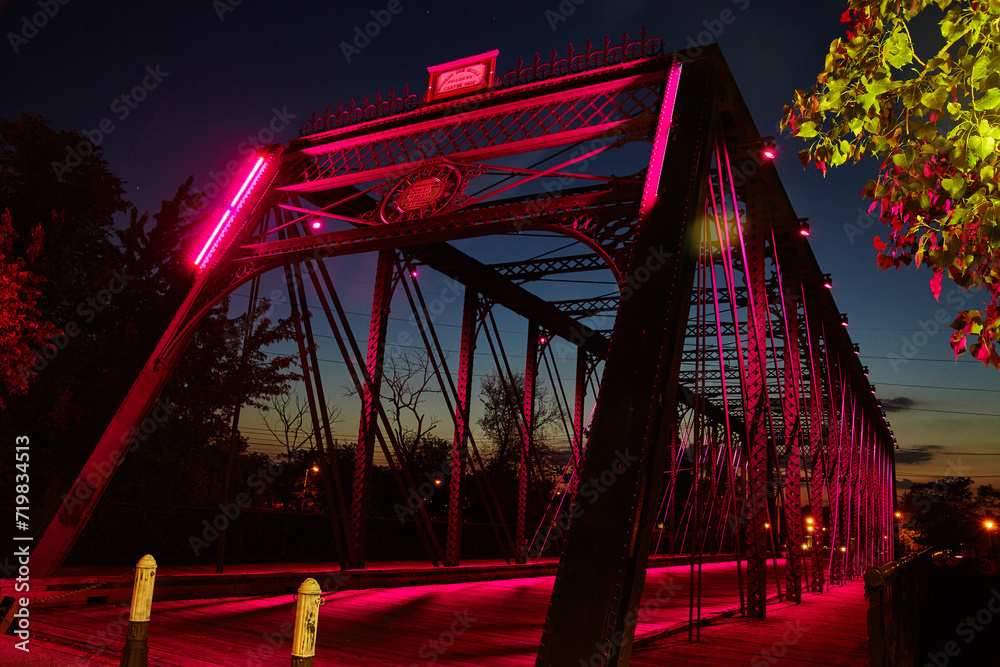 Illuminated Historic Truss Bridge at Twilight with Greenery Stock Photo ...