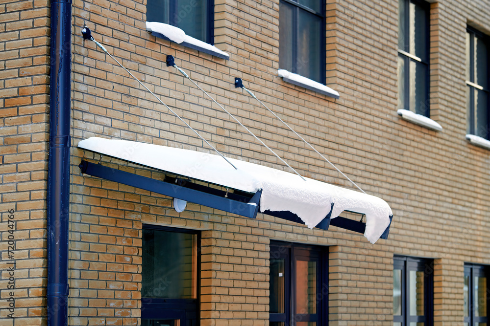 Glass canopy covered with snow after snow storm. Door canopy with ...