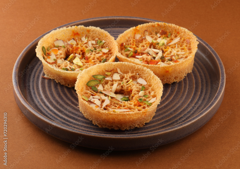 Indian Rajasthani crunchy sweet dish called Ghevar or Ghewar is an made ...