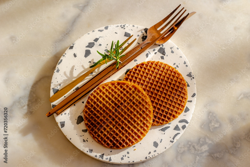 Stroopwafel on the table with sunlight as background, Dutch waffle made ...