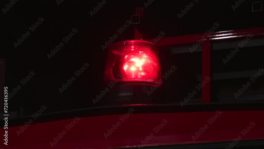 Red Emergency Flashing Siren Light on fire truck in front of dark ...