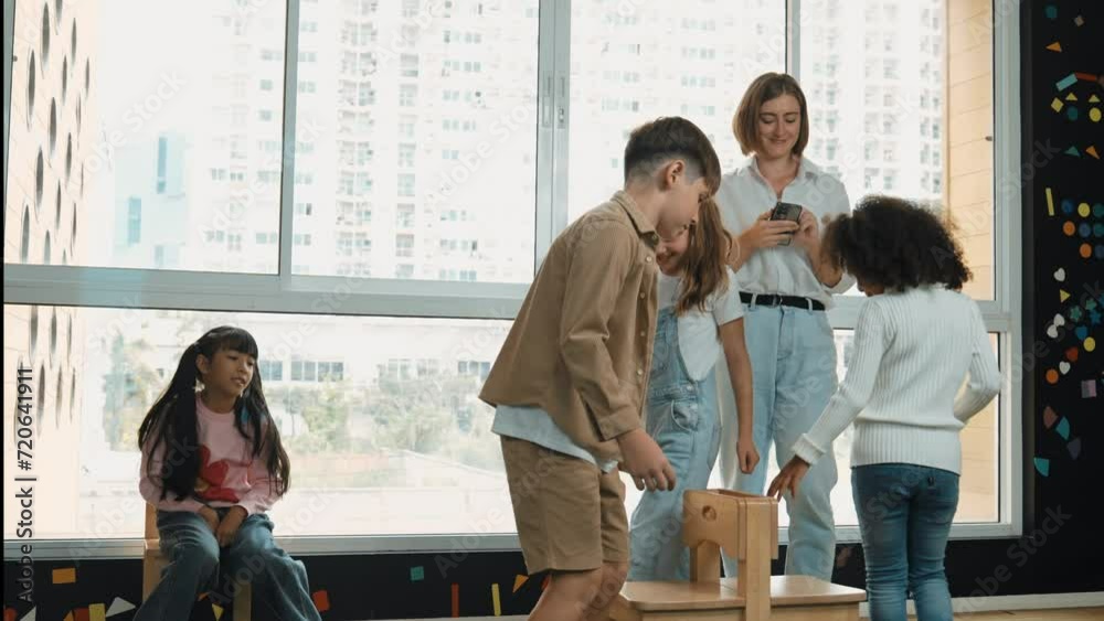 Vidéo Stock Diverse children playing musical chairs games while young ...